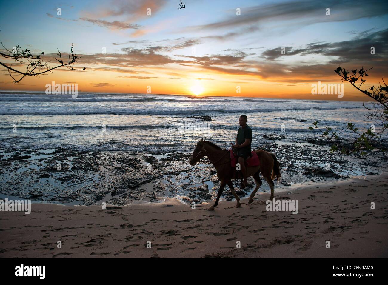 Riding horses at sunset hi-res stock photography and images - Alamy