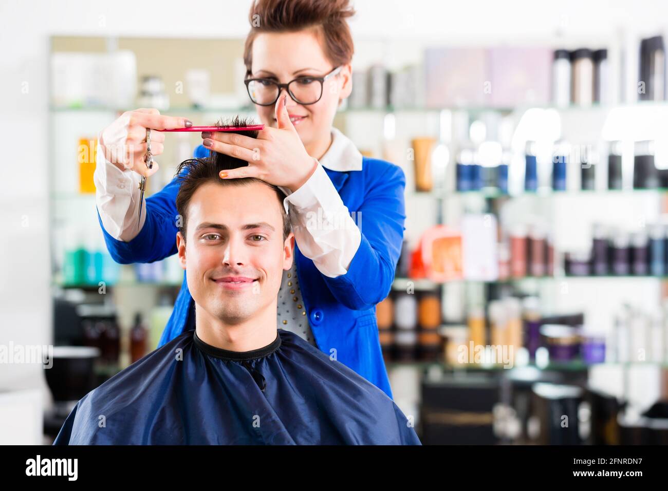 Female coiffeur cutting men hair in hairdresser shop Stock Photo - Alamy