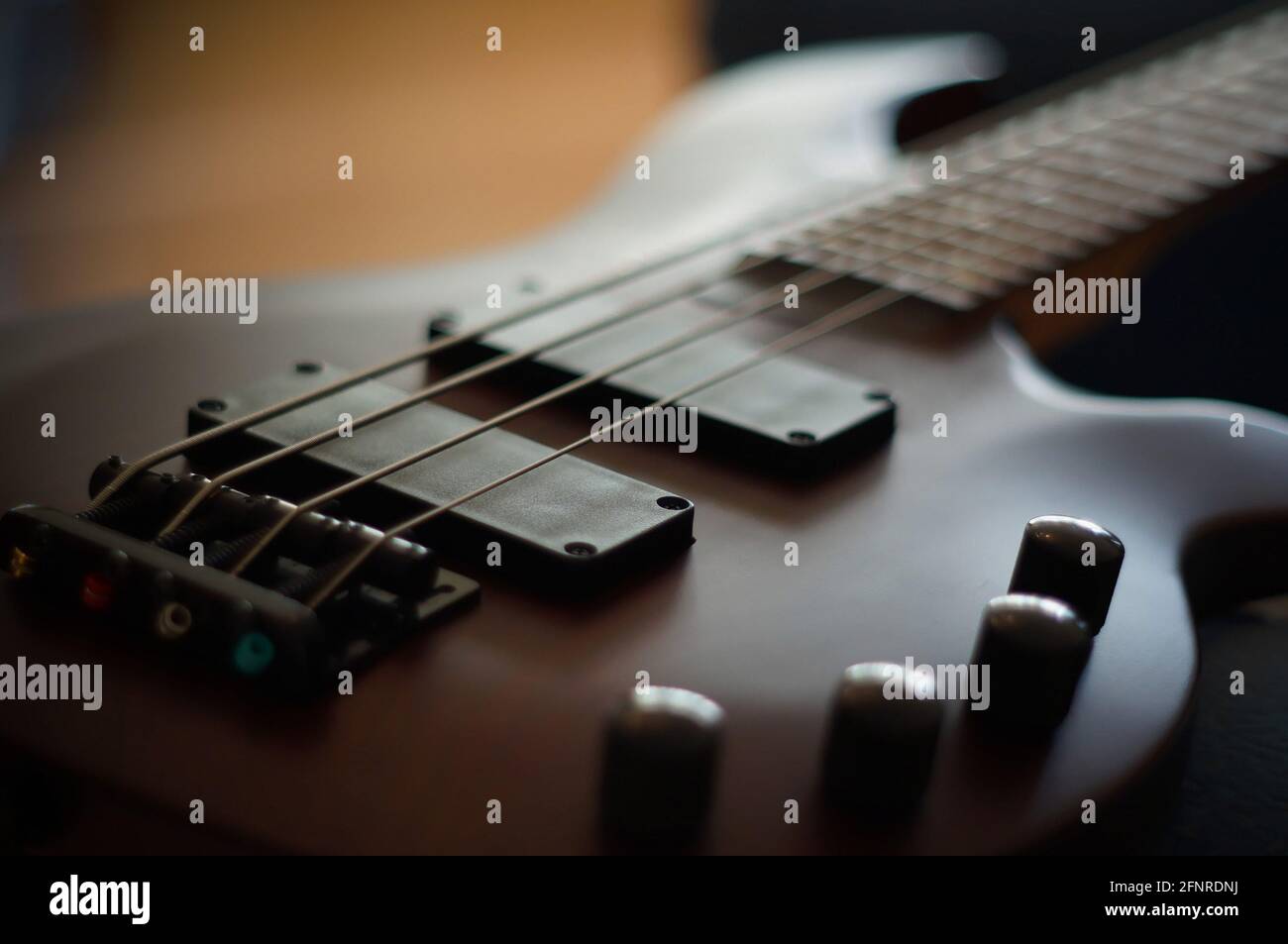 Closeup shot of a smooth body, pickups, bridge, knobs and strings of a ...