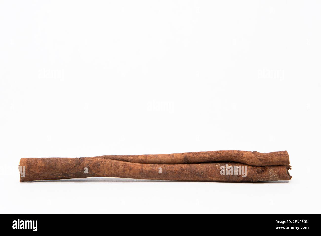 Single cinnamon stick on white background. Front view. Copy space Stock ...