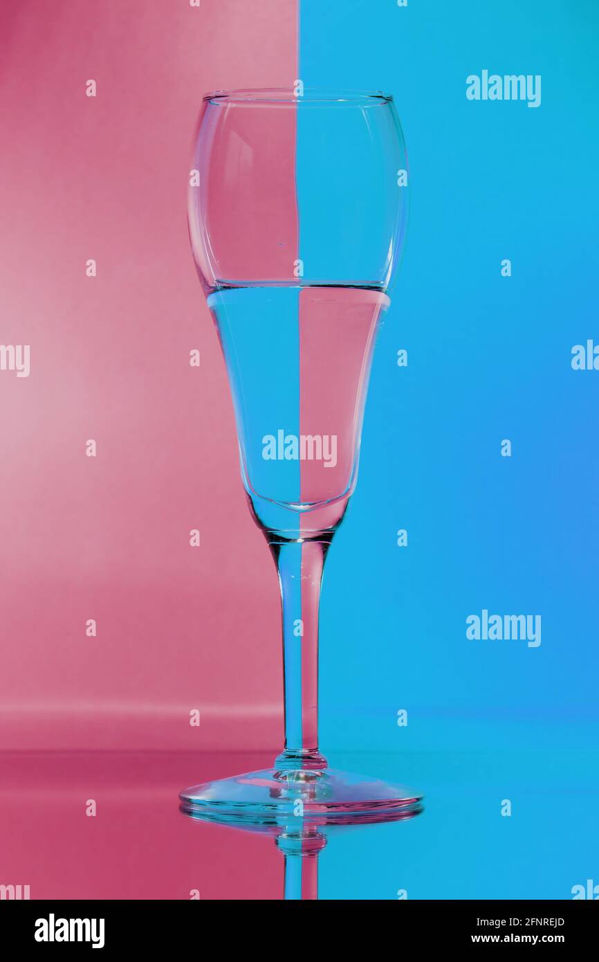 refraction of light by a glass on a red and blue squared background ...