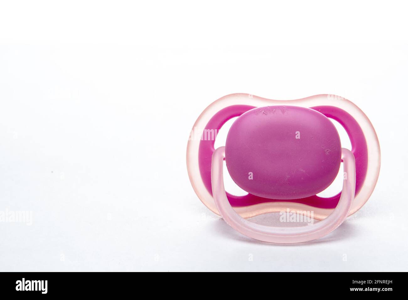 Pink baby's orthodontic pacifier isolated on white background. Front ...