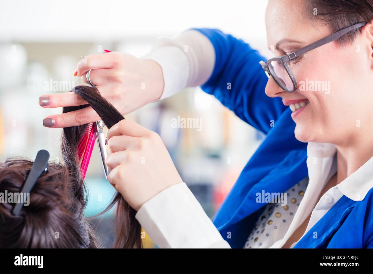 Female coiffeur divide women hair in sections with clips in shop Stock ...