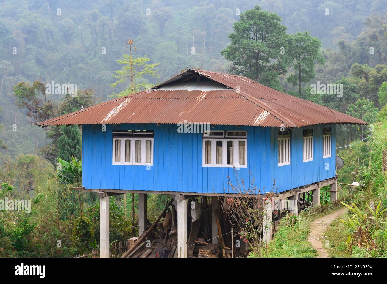 Traditional Lepcha Cottage with concrete pillars. Open space below the ...