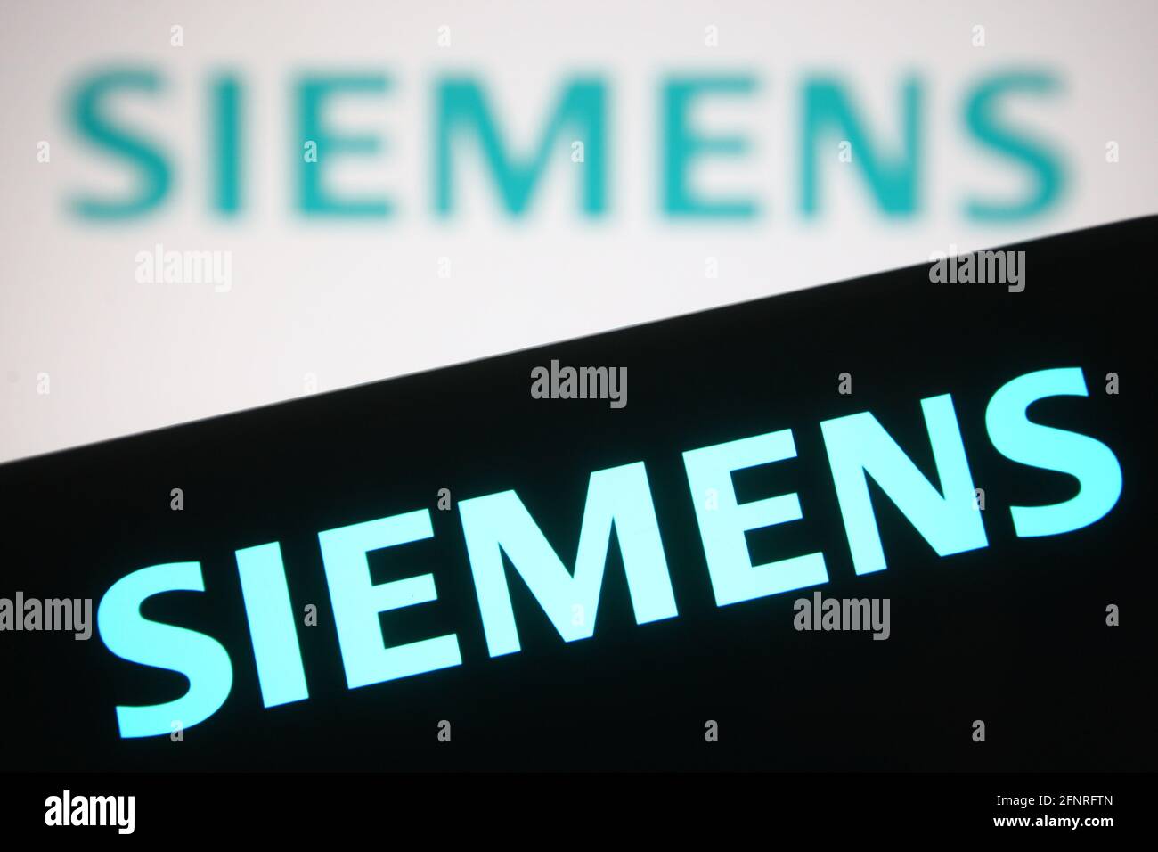 In this photo illustration the Siemens logo is seen on a smartphone and ...