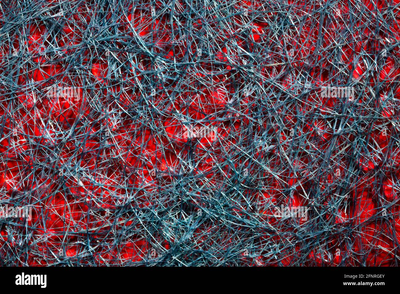 Abstract background of blue plastic threads on a red backdrop Stock ...