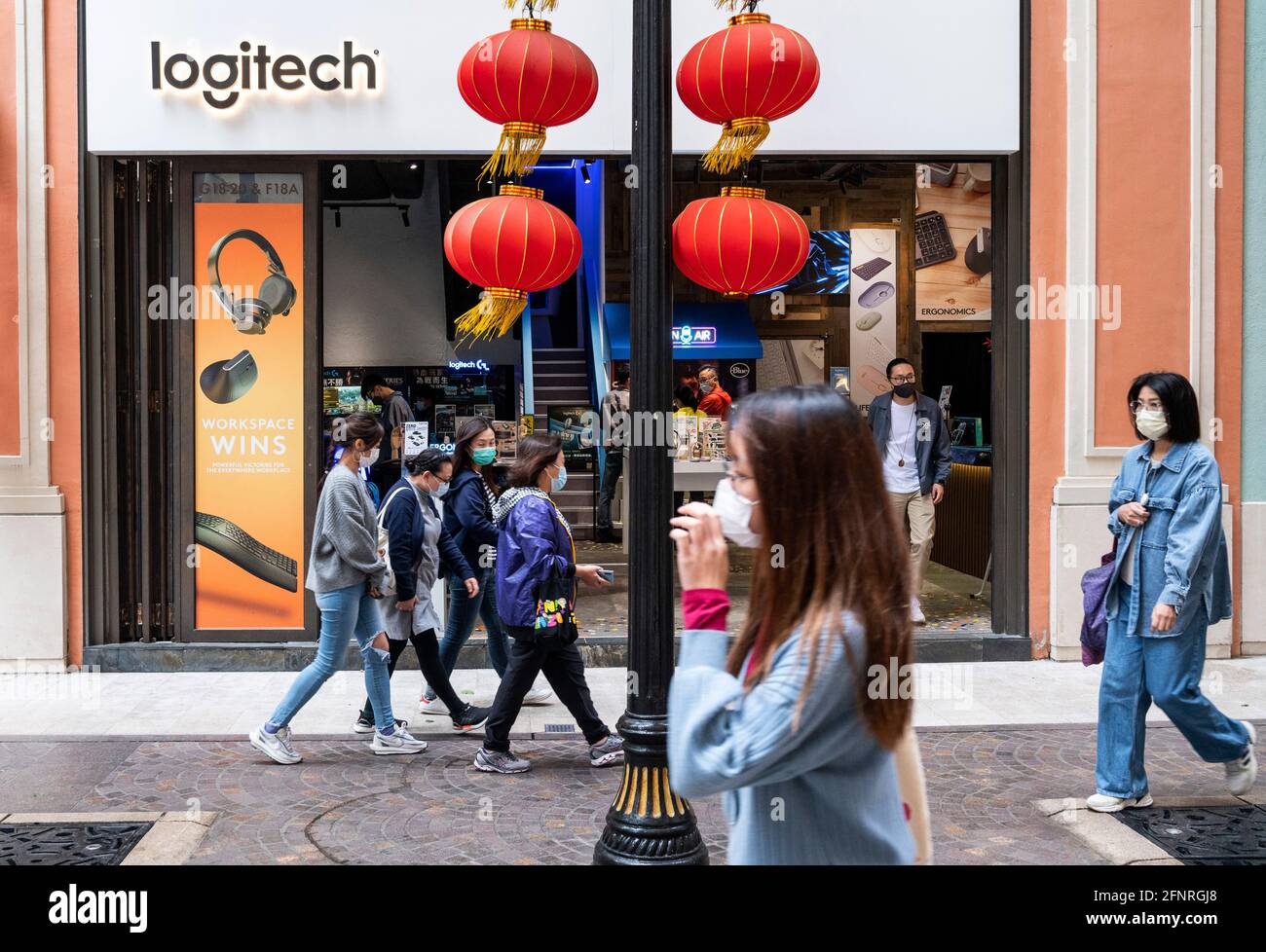 Pedestrians walk past the Swiss electronics company Logitech store in ...