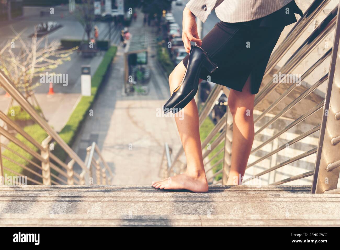 Beautiful business woman injury with shoe pinches her feet. Take off ...