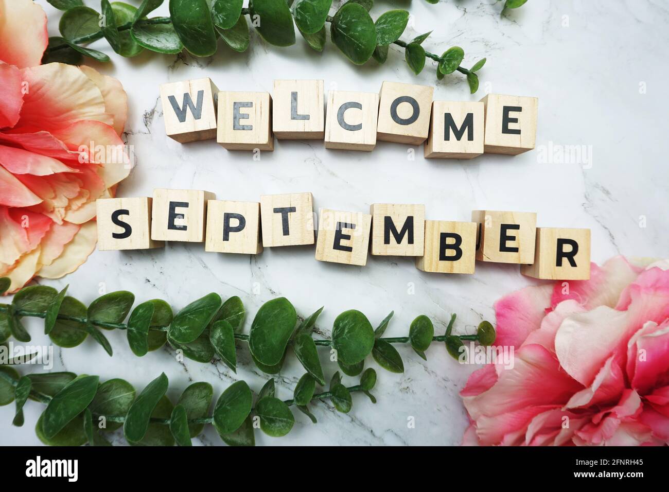 Welcome September alphabet letter with green leave and pink flower flat ...