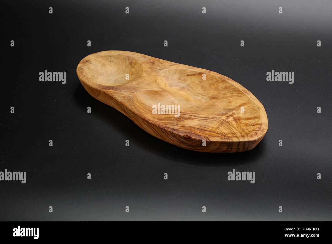 Olive tree board for kitchen over black background Stock Photo - Alamy