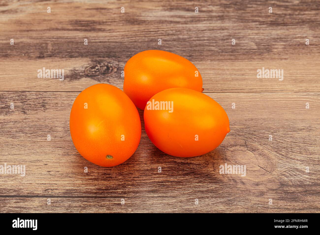 Tasty vegetables - Yellow tomato heap over background Stock Photo - Alamy