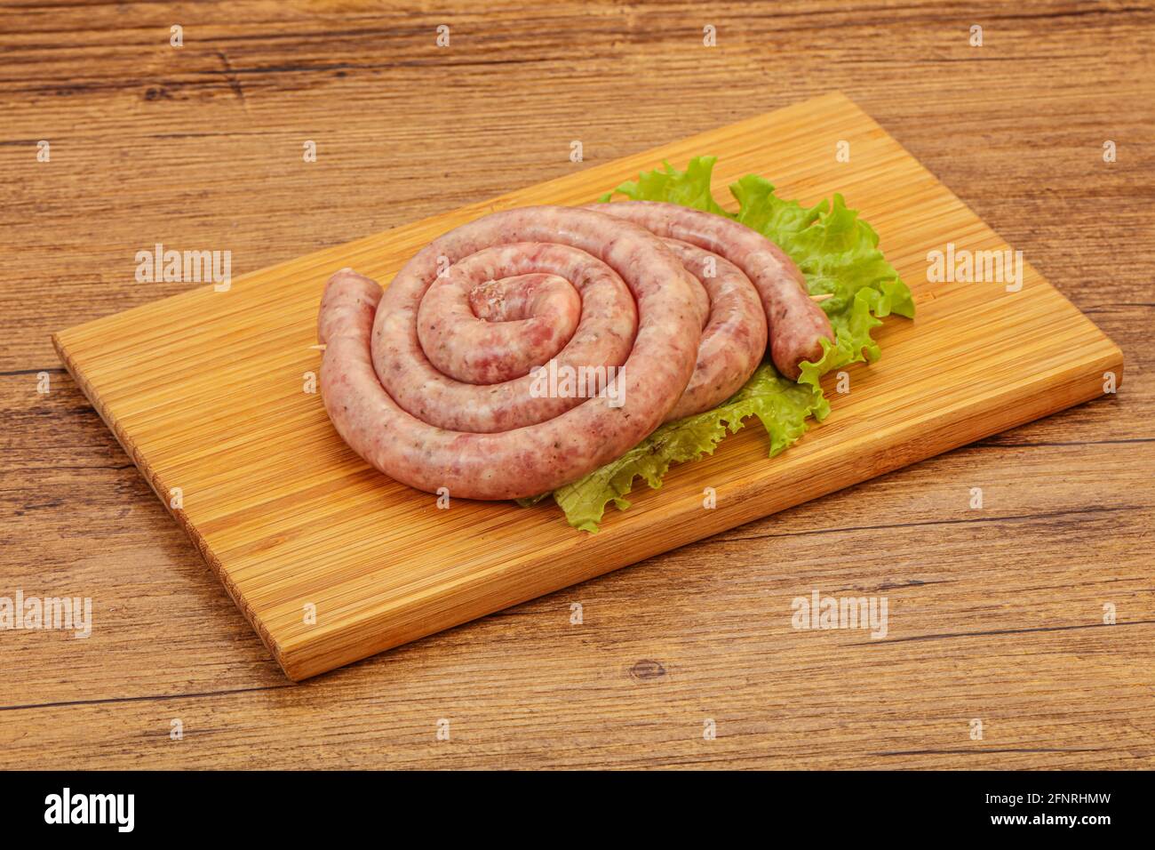 Raw pork sausage ring for grill Stock Photo - Alamy