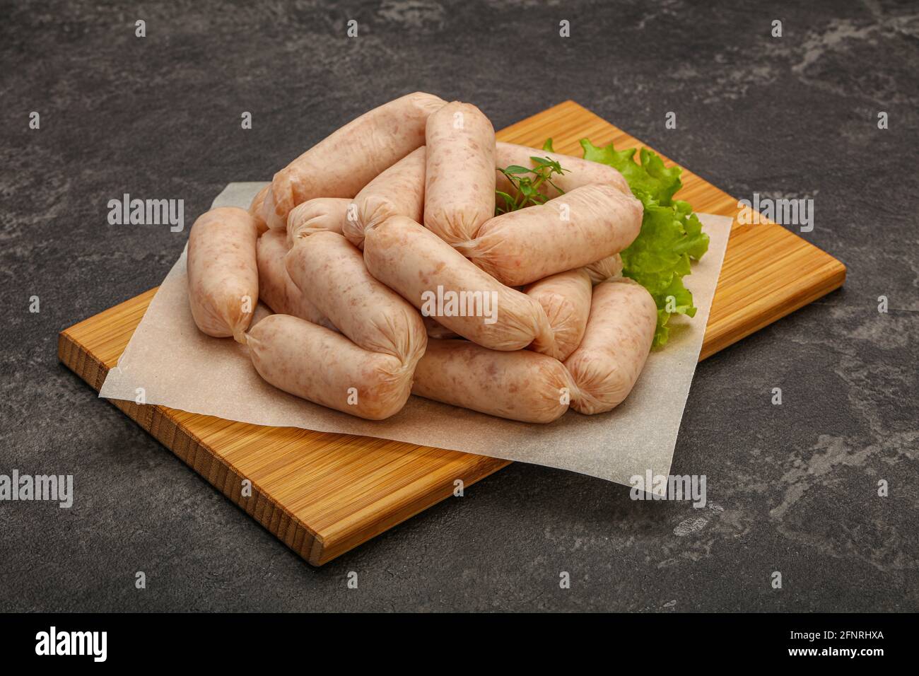 Raw natural chicken baby sausages for roast Stock Photo - Alamy