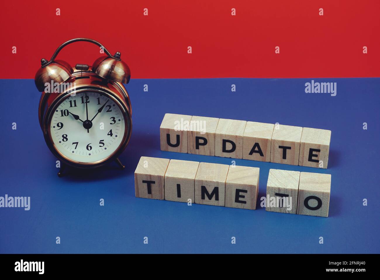 Time to Update alphabet letter with alarm clock on blue and red ...