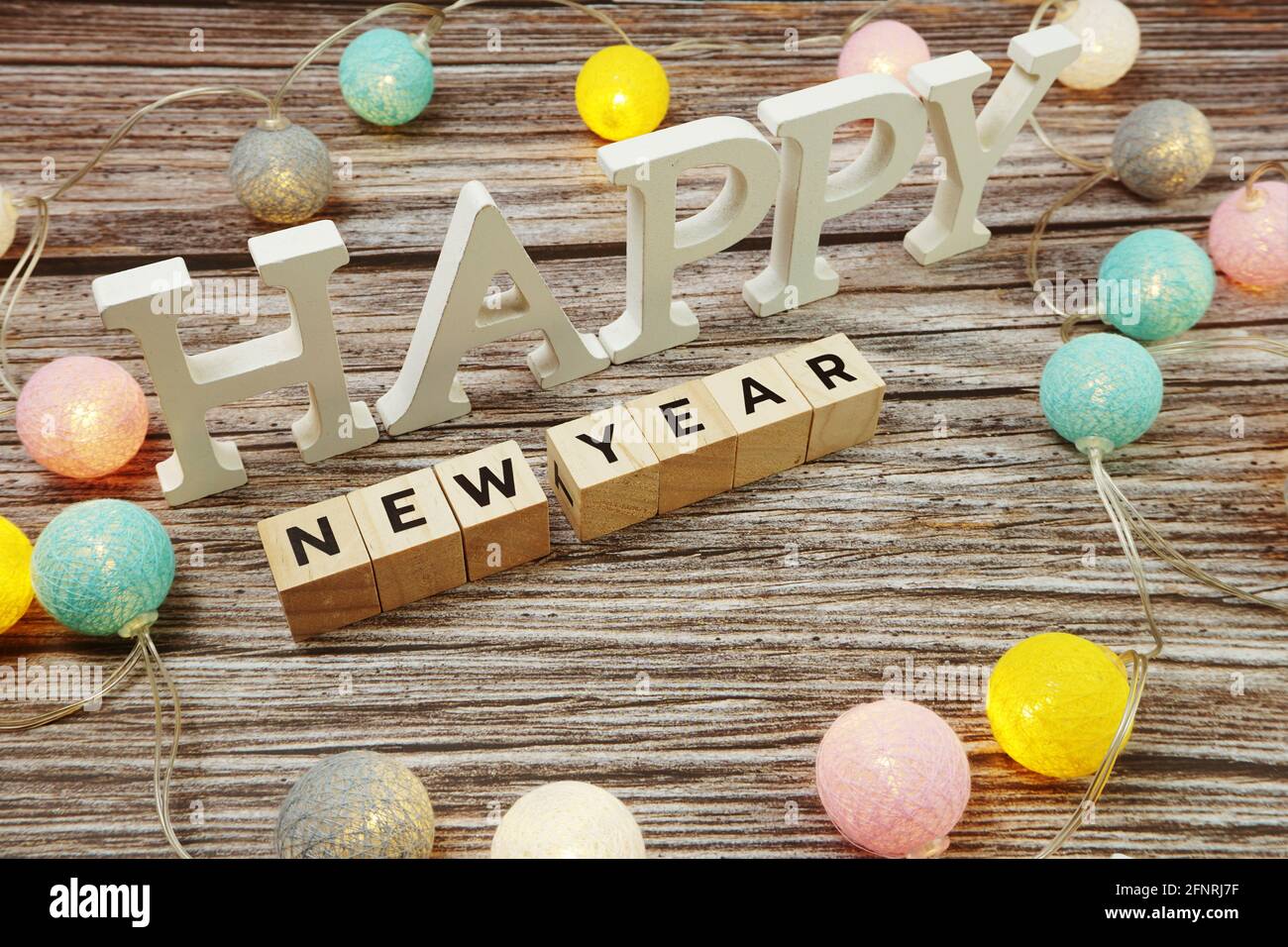 Happy New Year with LED cotton balls decoration on wooden background ...