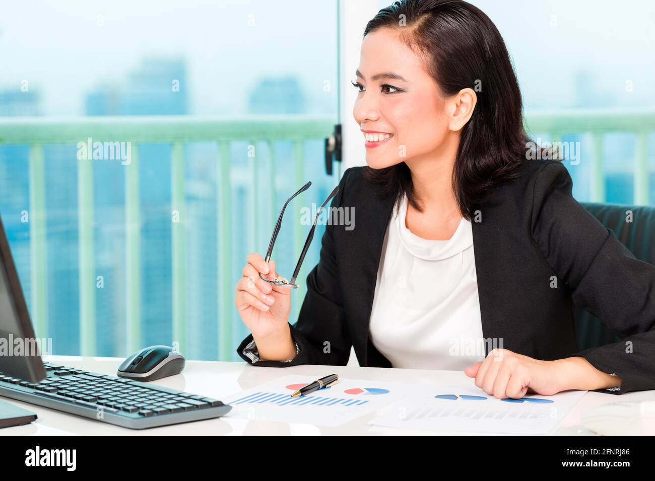 Asian Chinese business woman working in office controlling profit Stock ...
