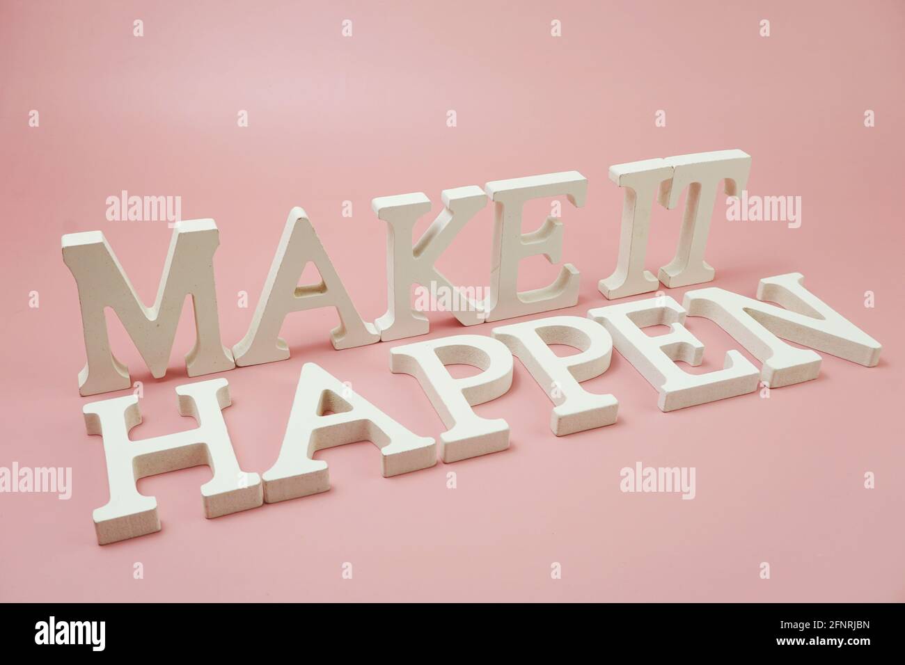 Make It Happen word alphabet letters on pink background Stock Photo - Alamy