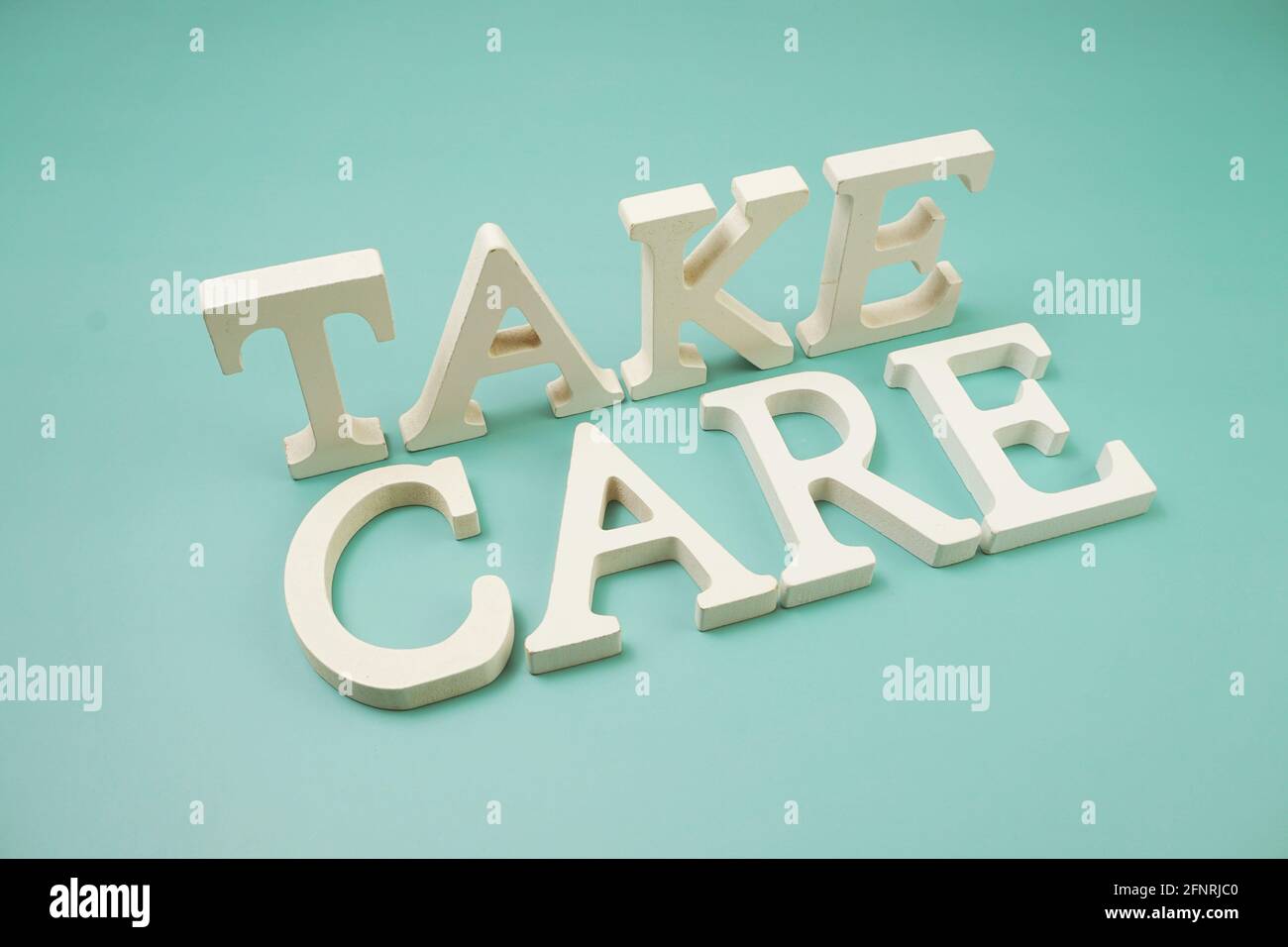 Take Care word alphabet letters on blue background Stock Photo - Alamy
