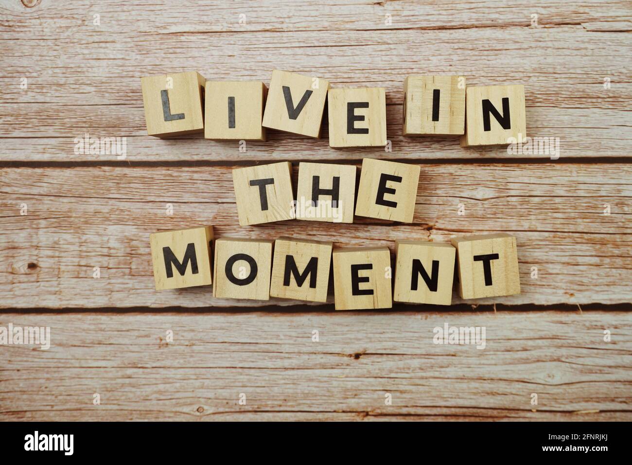 Live In The Moment alphabet letter on wooden background Stock Photo - Alamy