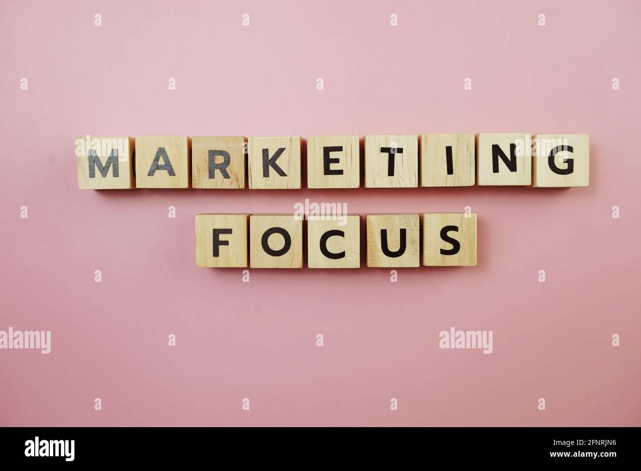 Marketing Focus alphabet letter on pink background Stock Photo - Alamy
