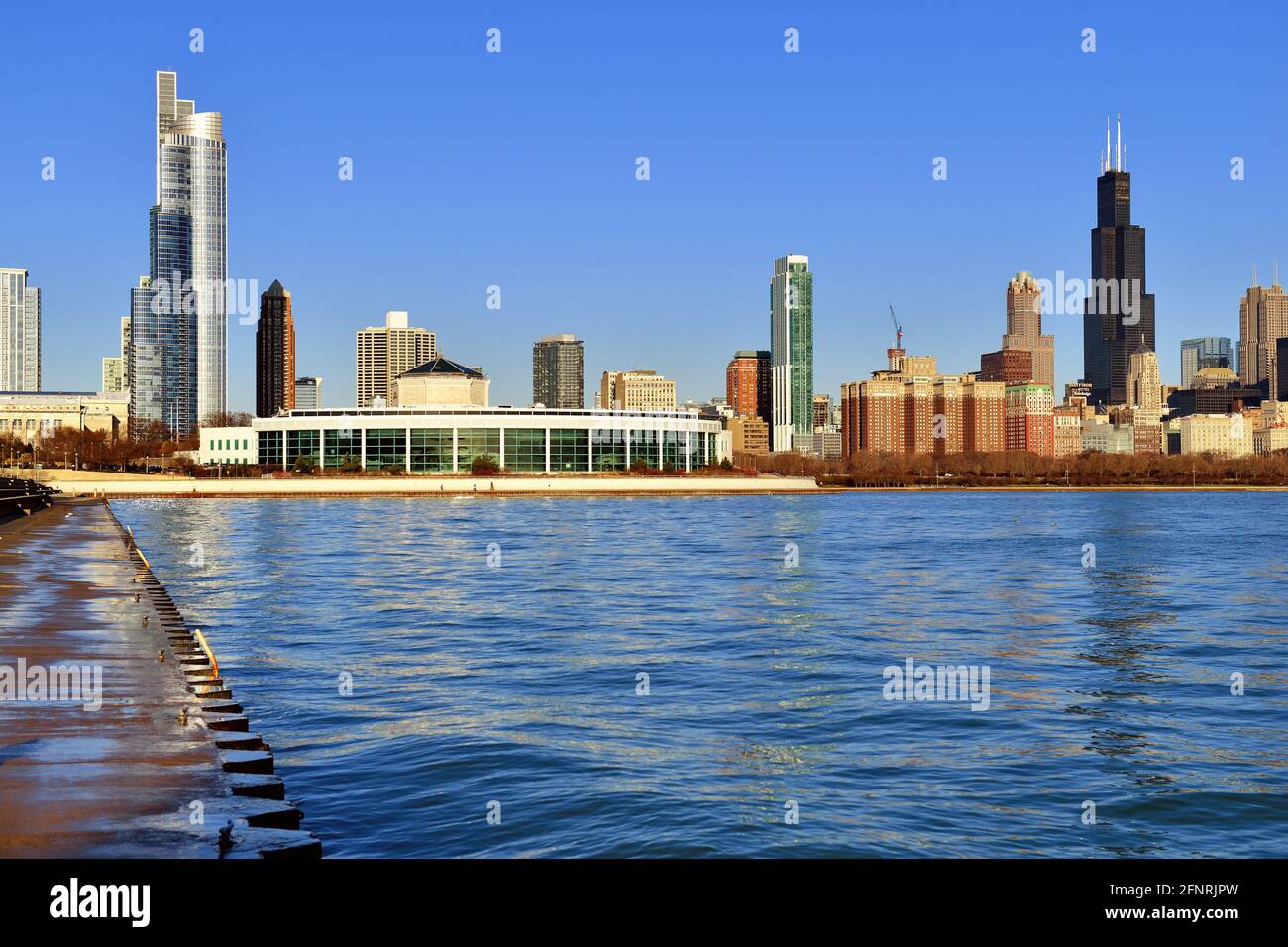The morning sun above Lake Michigan reflects off the Adler Planetarium ...
