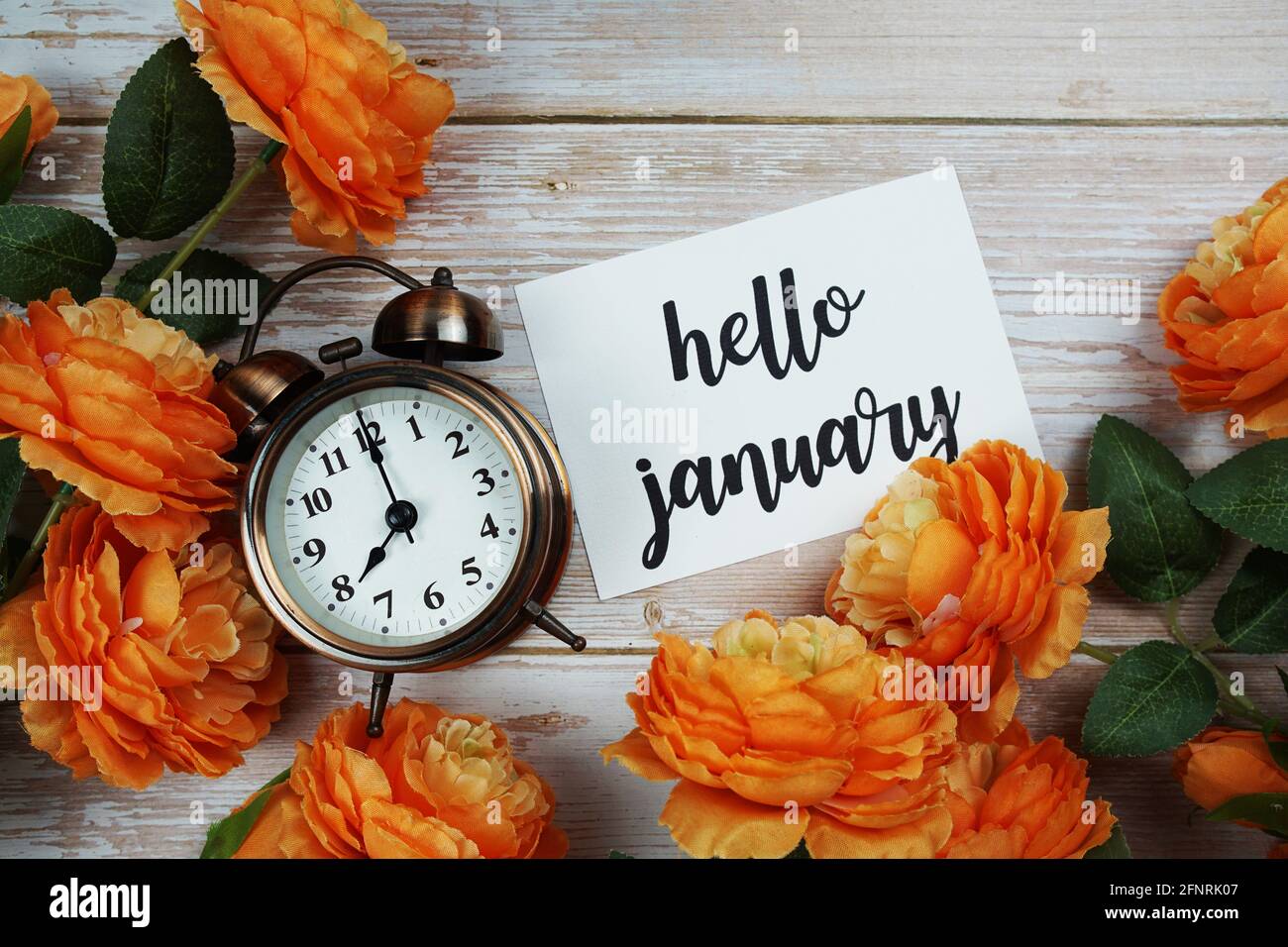 Hello January card and alarm clock with orange flower decoration on ...
