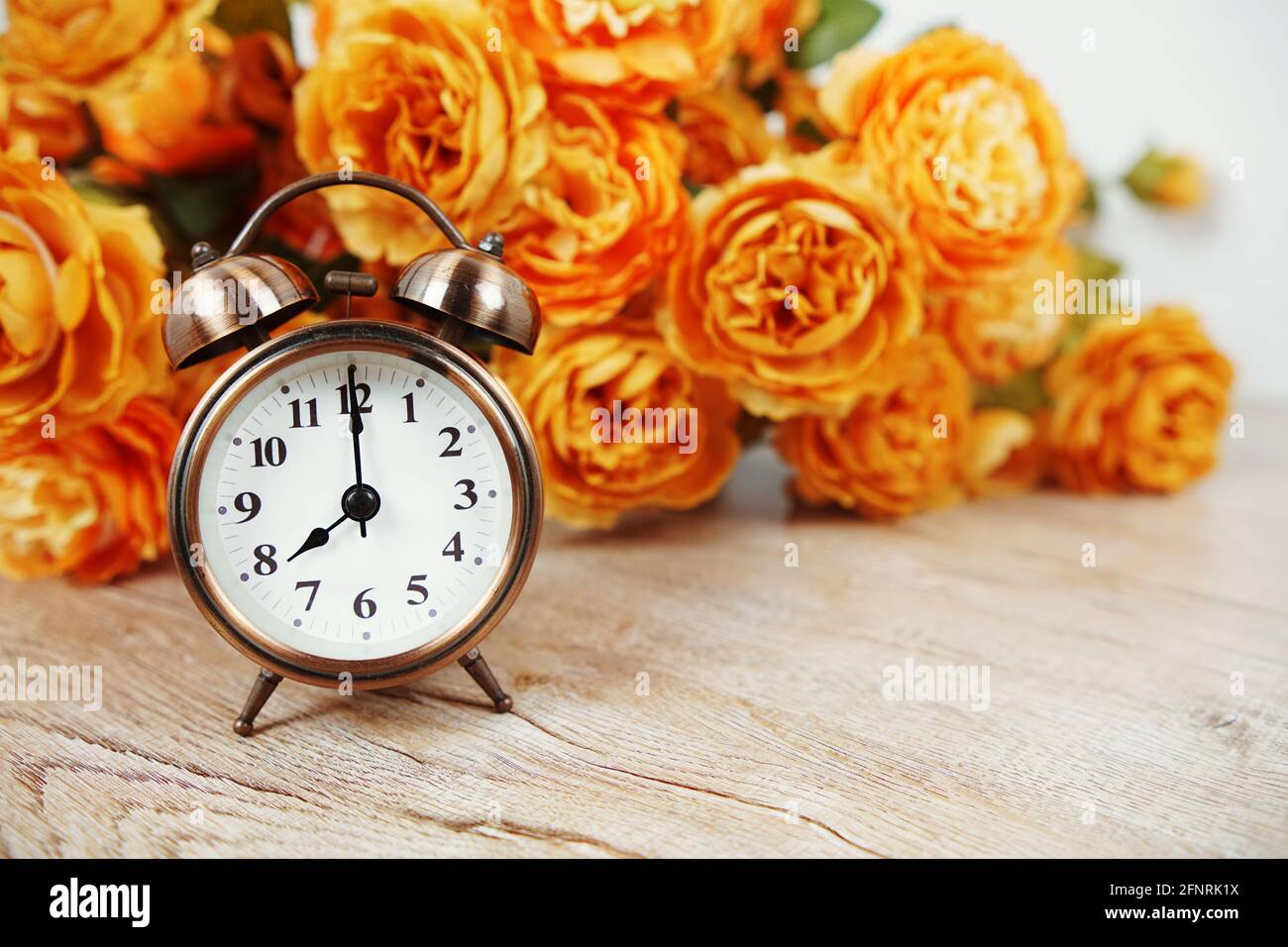 Vintage Alarm Clock And Flower Bouquet with space copy on wooden ...