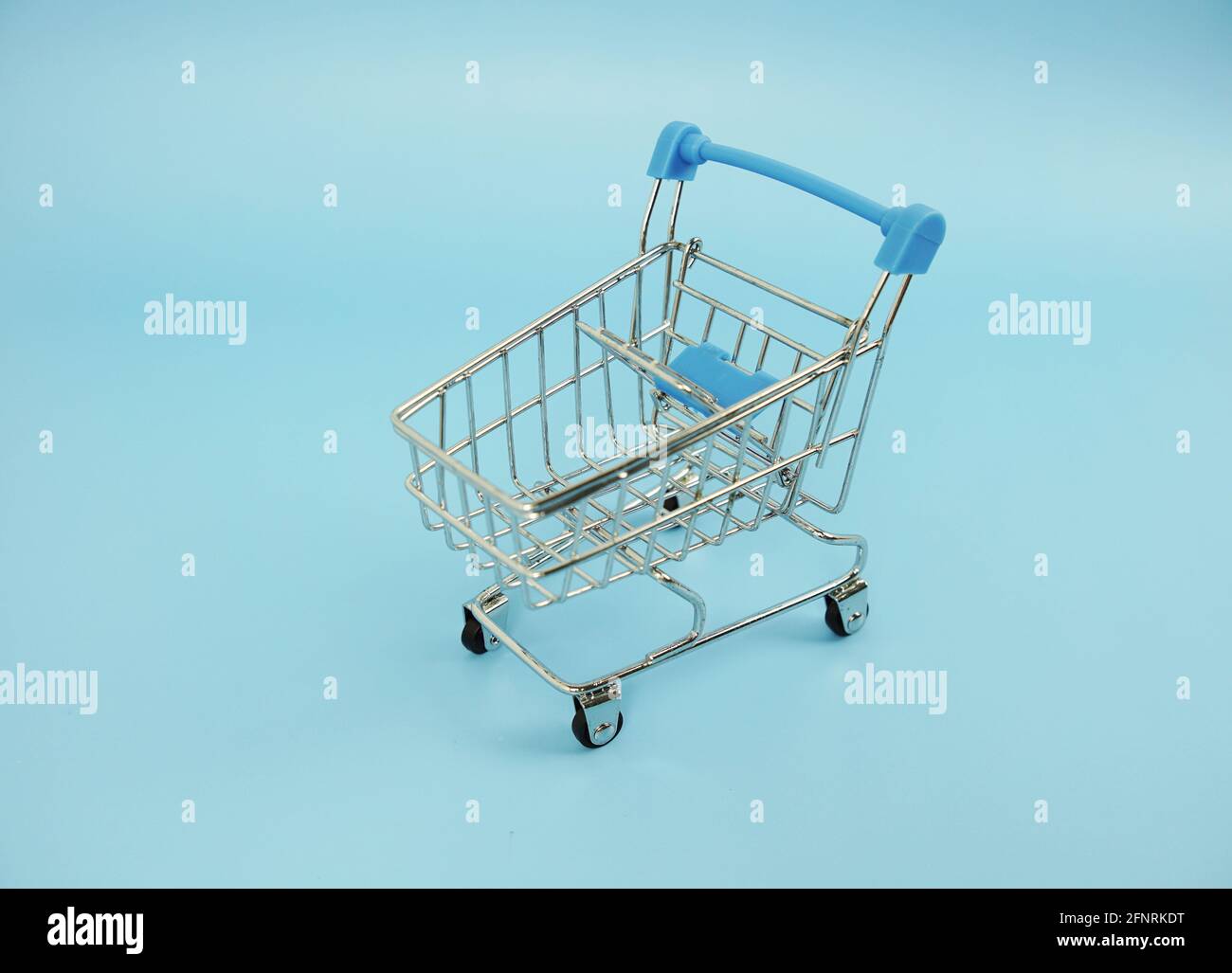 Mini trolley cart with space copy on blue background Stock Photo - Alamy