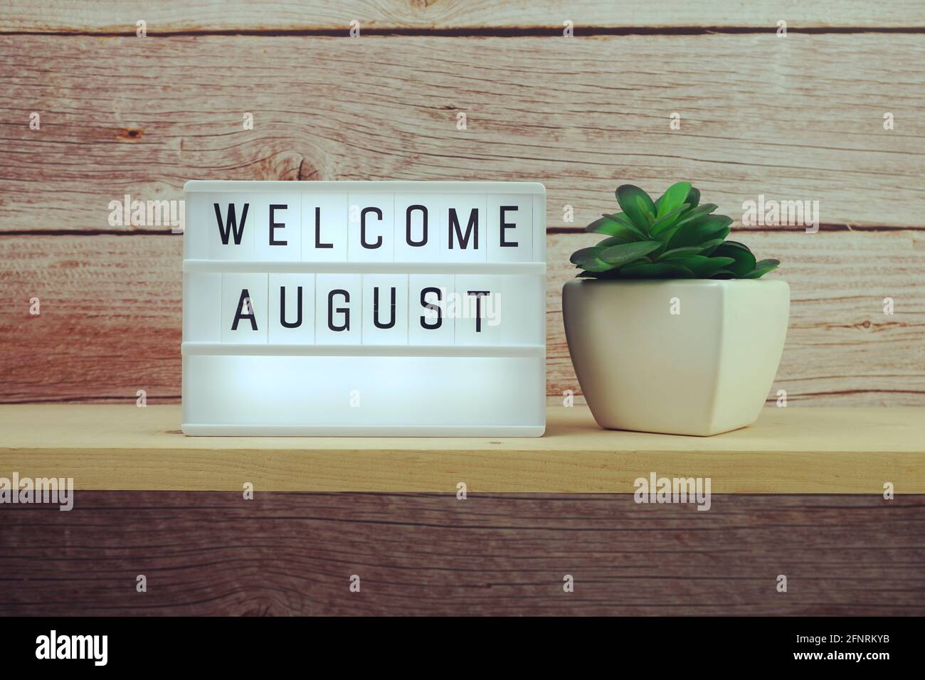 Welcome August word in light box on wooden shelves background Stock ...
