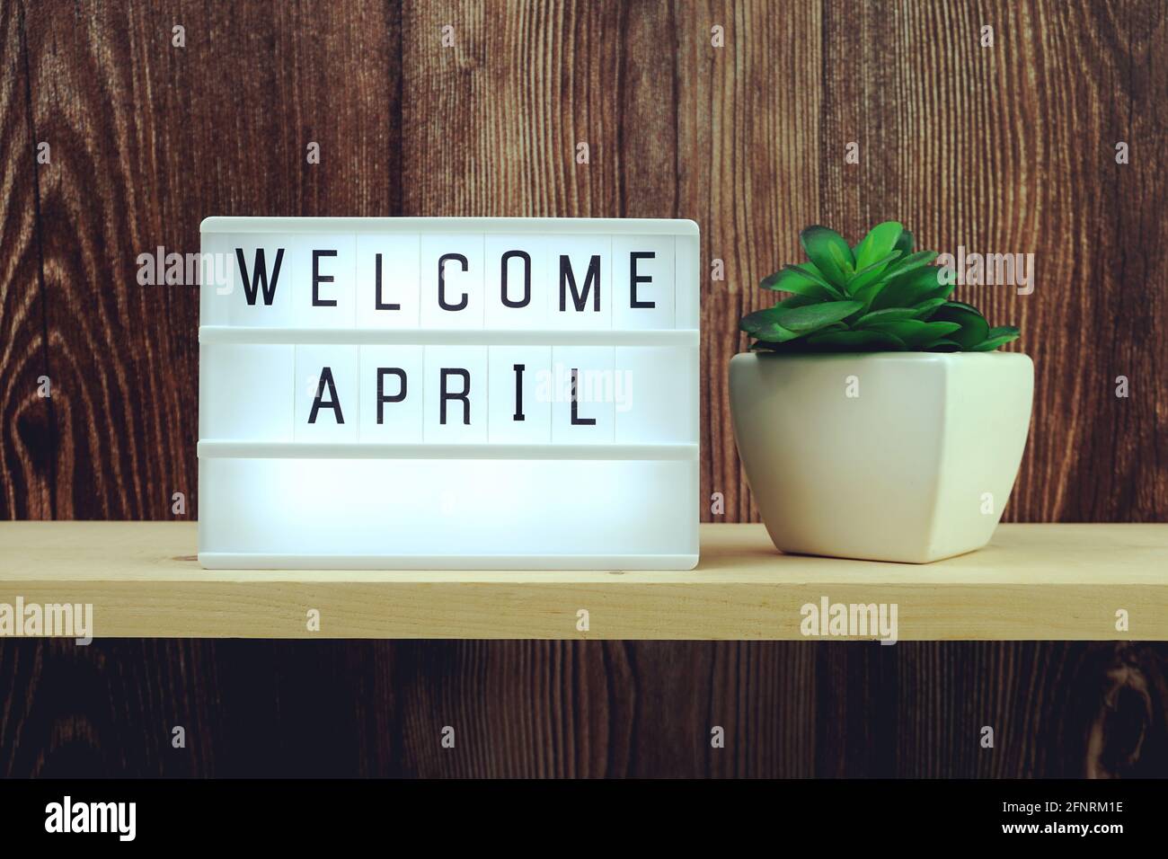 Welcome April word in light box on wooden shelves background Stock ...