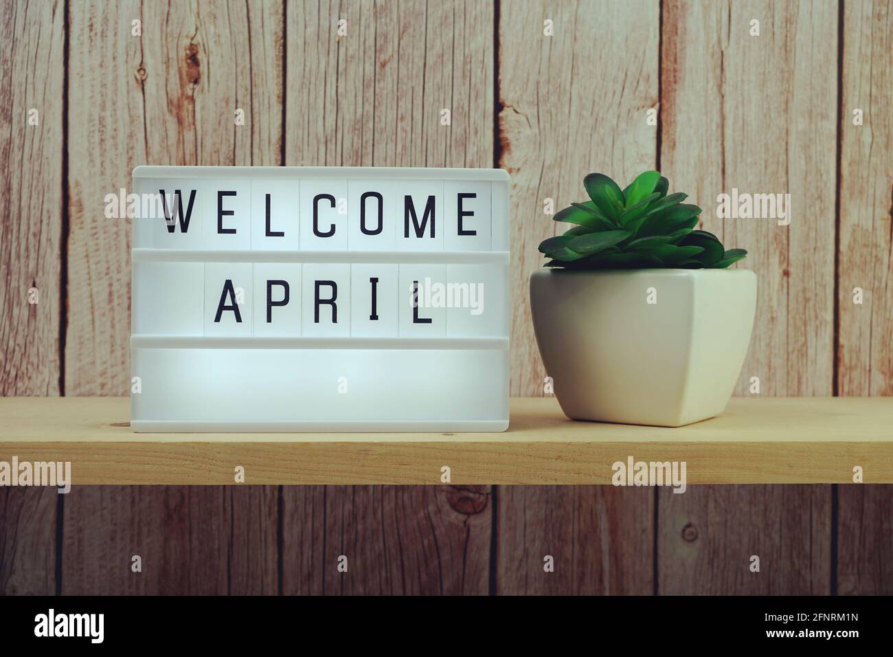 Welcome April word in light box on wooden shelves background Stock ...