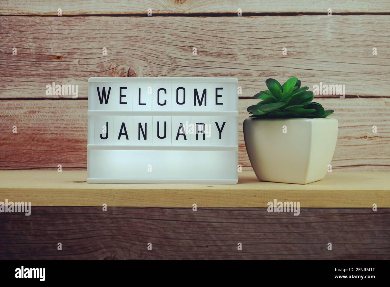 Welcome January word in light box on wooden shelves background Stock ...