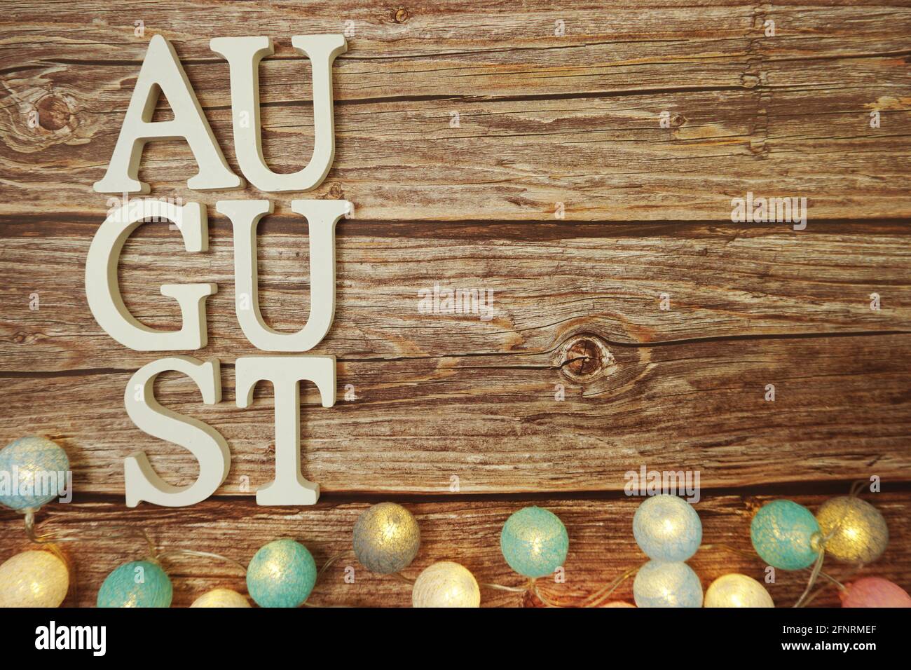 August alphabet letter with LED cotton balls on wooden background Stock ...