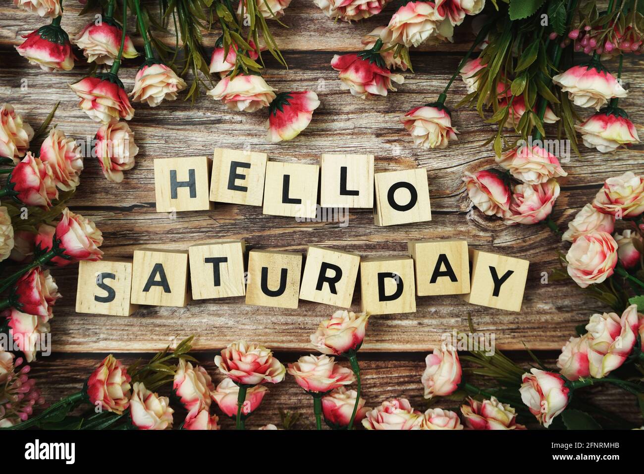 Hello Saturday alphabet letter with Blooming flower on wooden ...