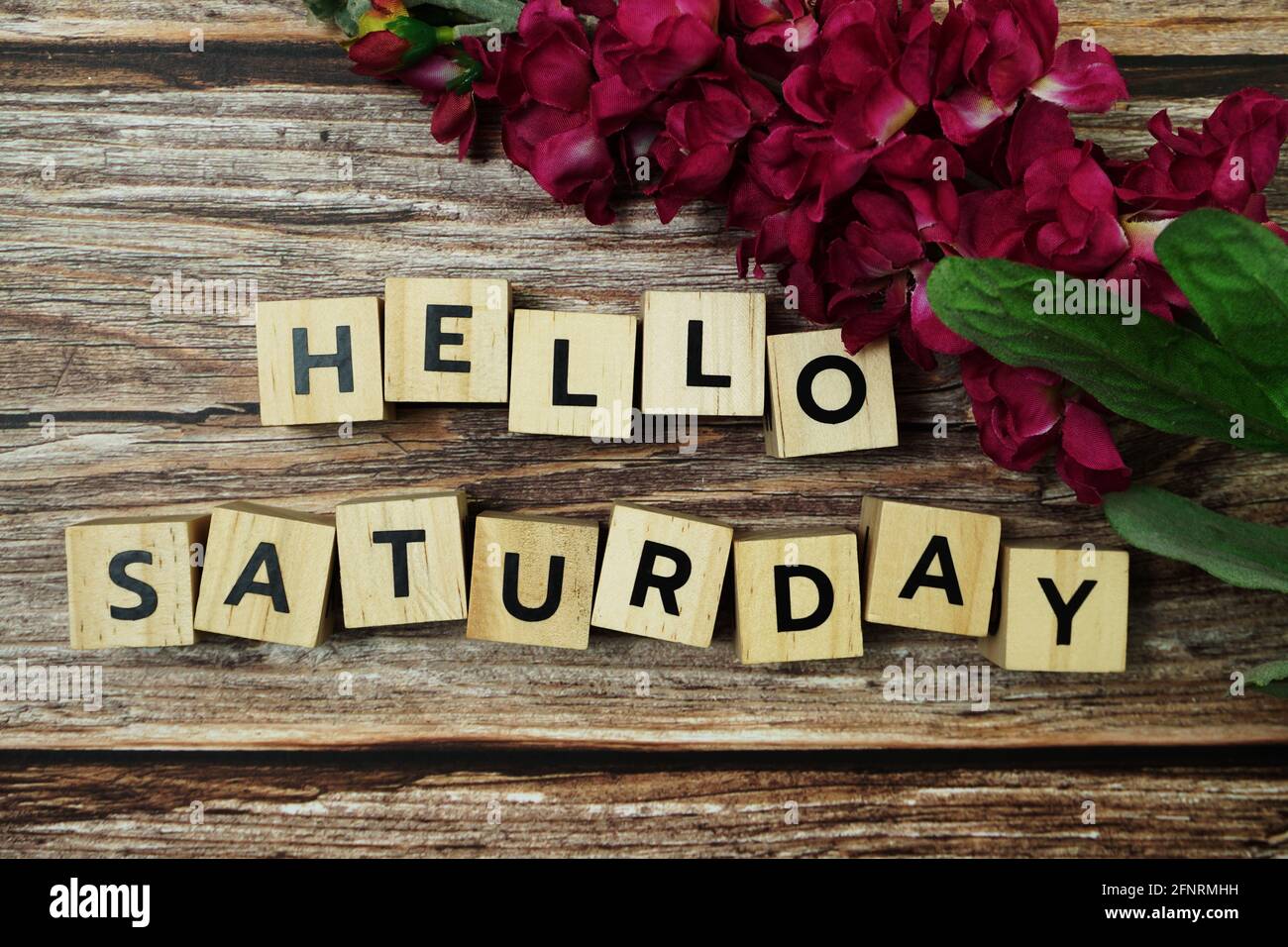 Hello Saturday alphabet letter with Blooming flower on wooden ...