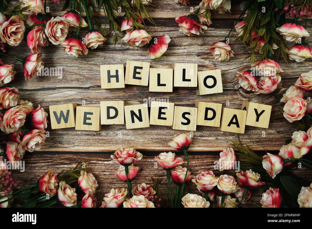 Hello Wednesday alphabet letter with Blooming flower on wooden ...