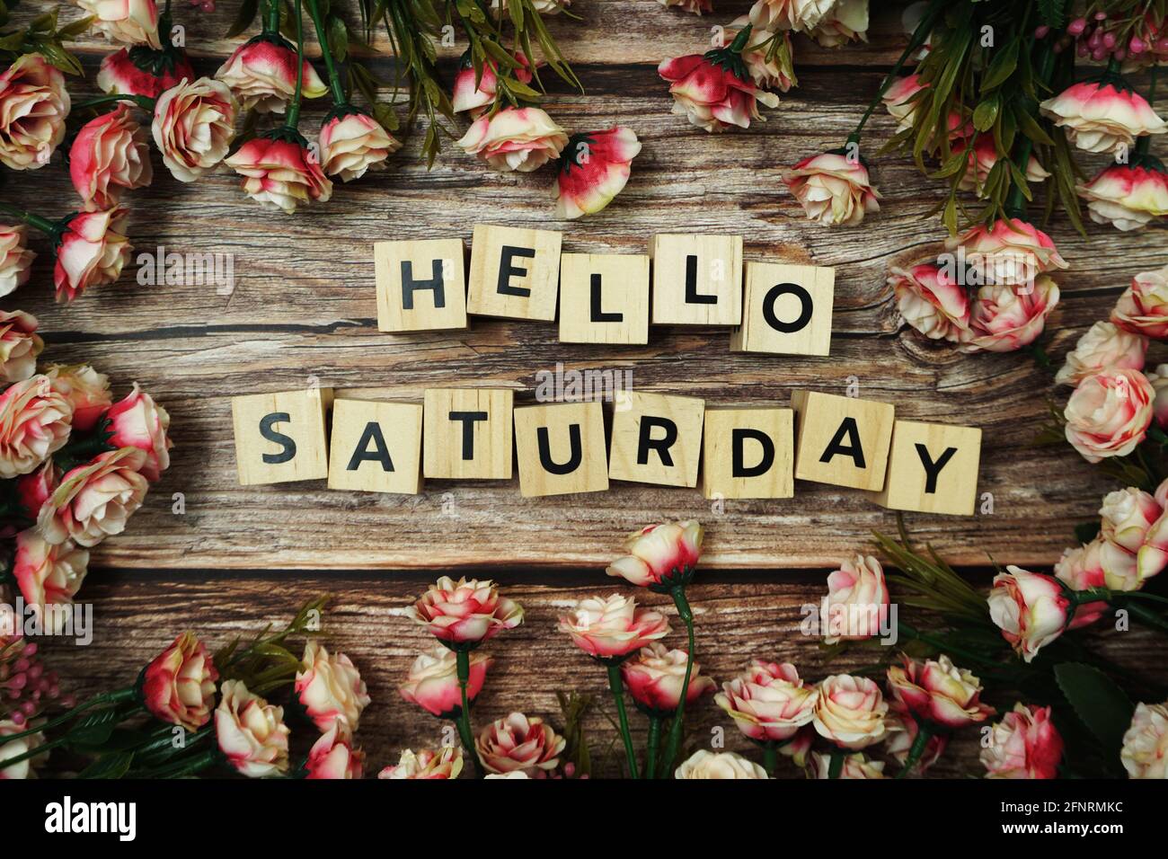 Hello Saturday alphabet letter with Blooming flower on wooden ...