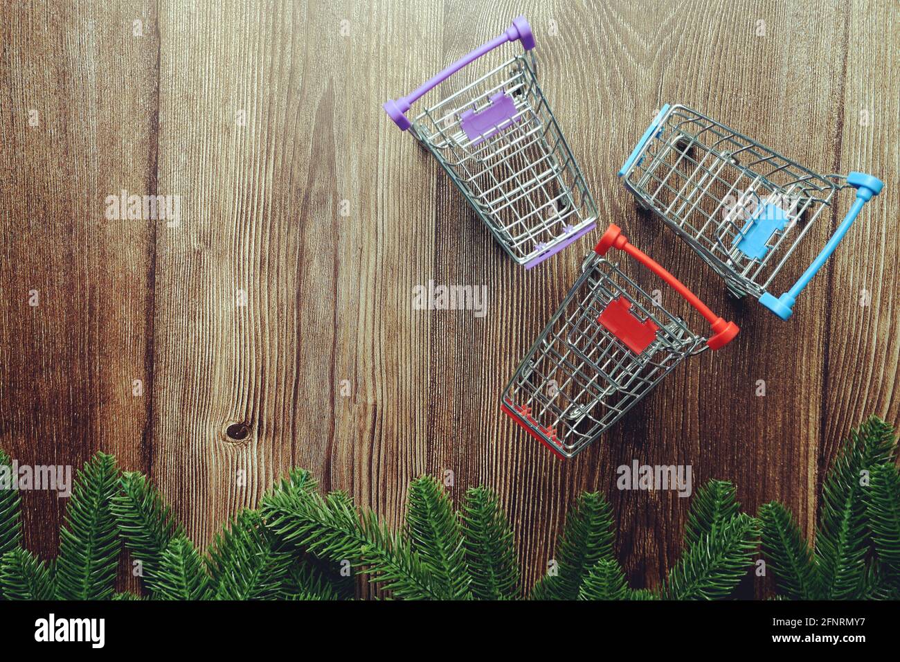 Mini Shopping Trolley with fir tree branches border frame on wooden ...
