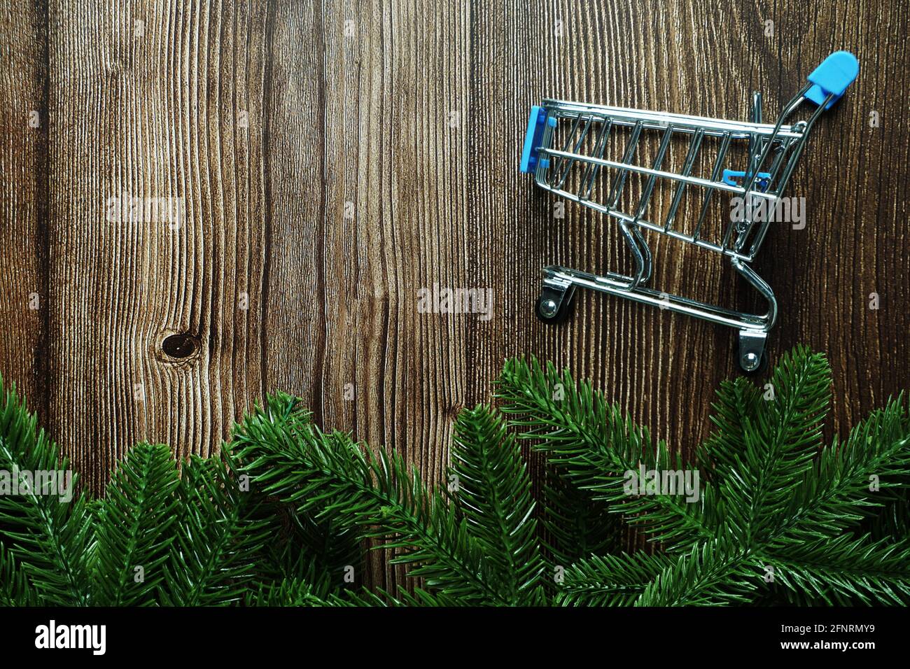 Mini Shopping Trolley with fir tree branches border frame on wooden ...