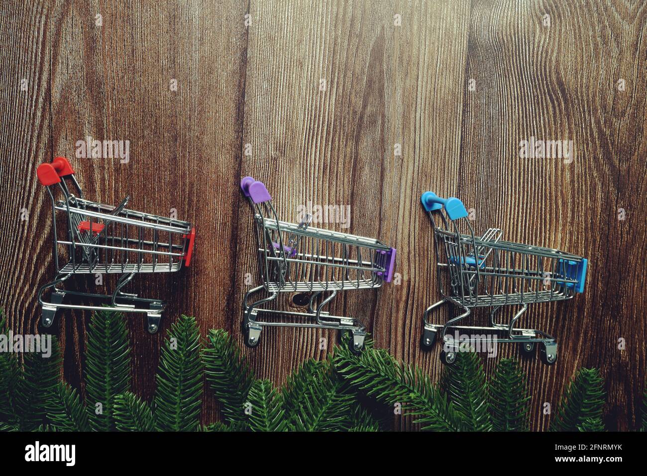 Mini Shopping Trolley with fir tree branches border frame on wooden ...