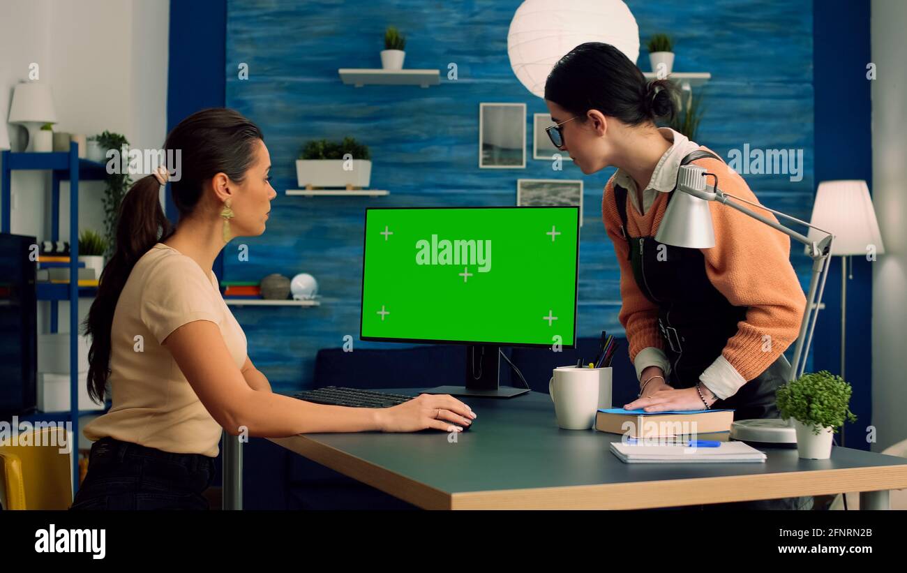 Teammates sitting on desk table while talking about business ...