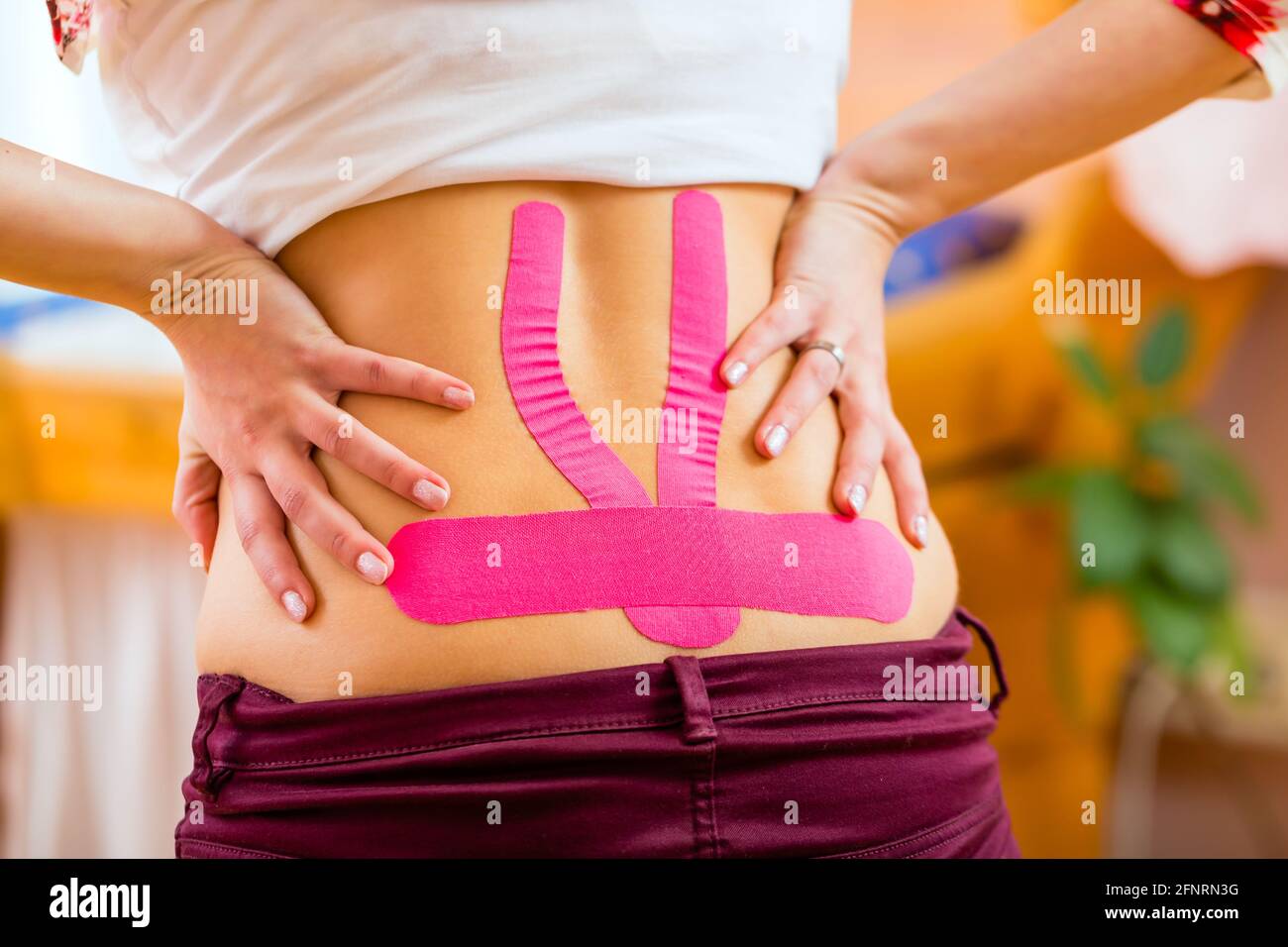 Pregnant woman wearing Kinesio-Tape against back pain Stock Photo - Alamy