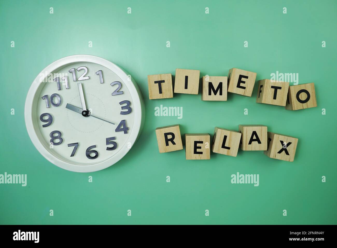 Time To Relax alphabet letter with alarm clock on wooden background ...