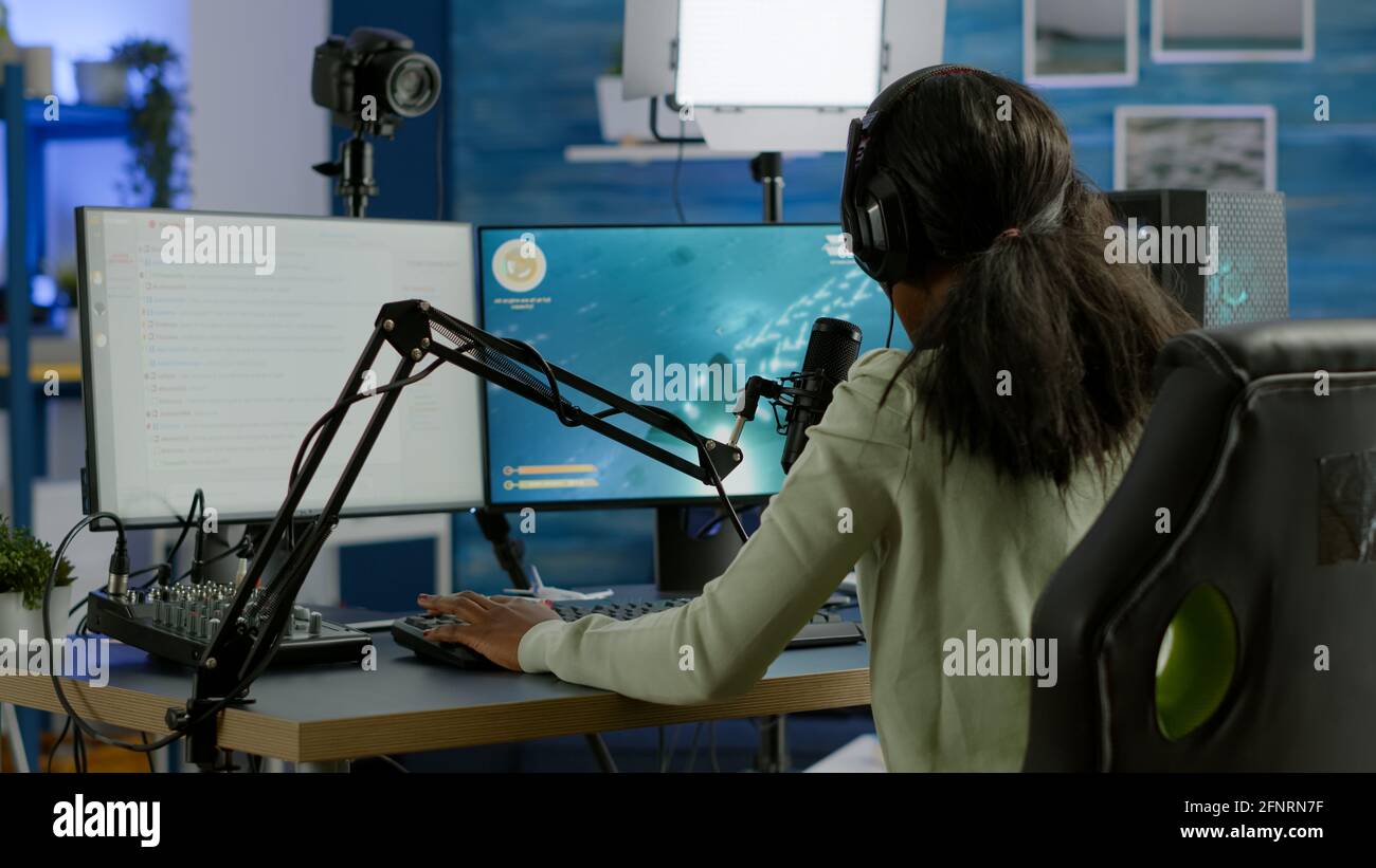 Black player wearing headphones talking with other players chatting ...