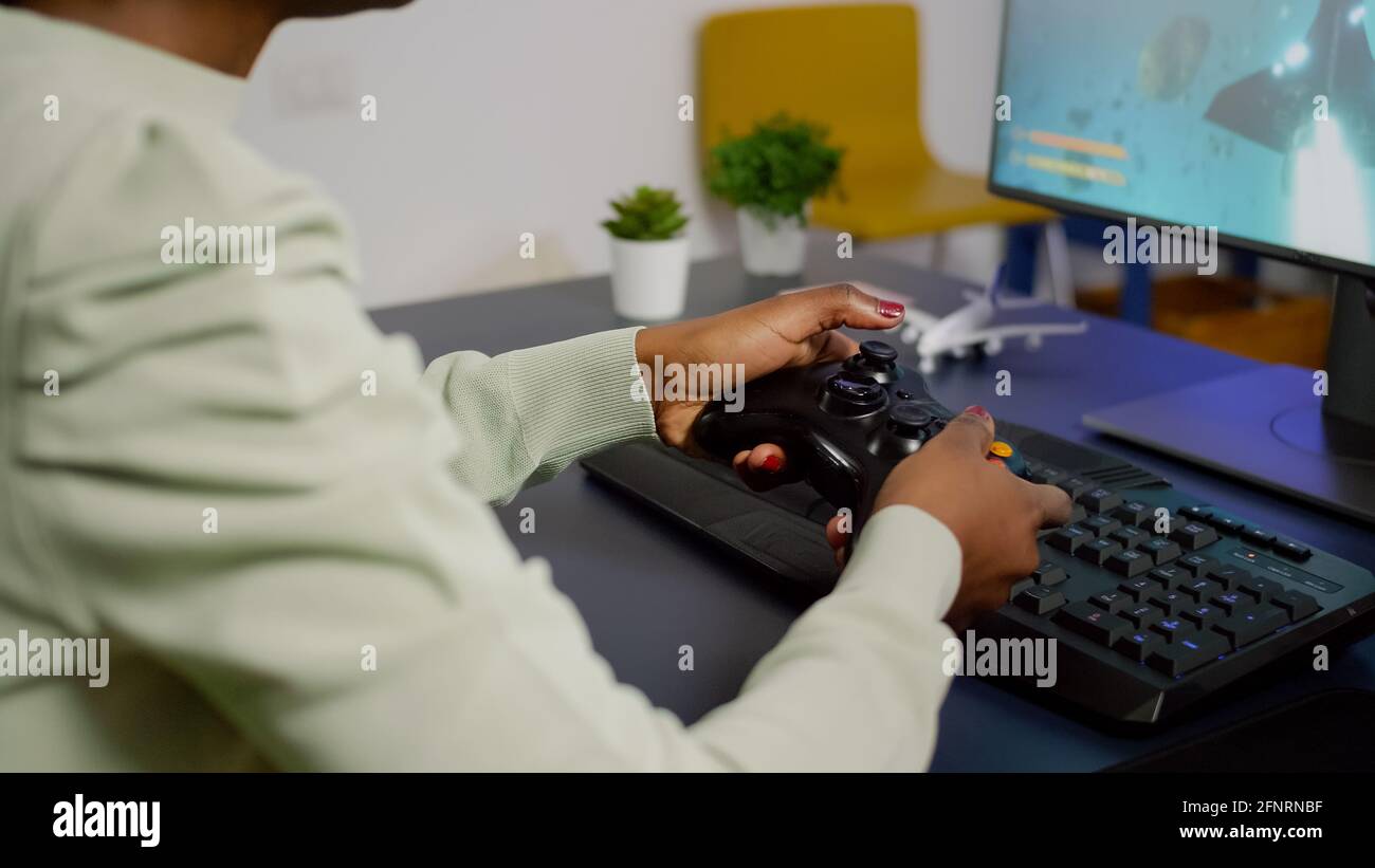 Closeup of wireless joystick and RGB keyboard, pro video gamer playing ...