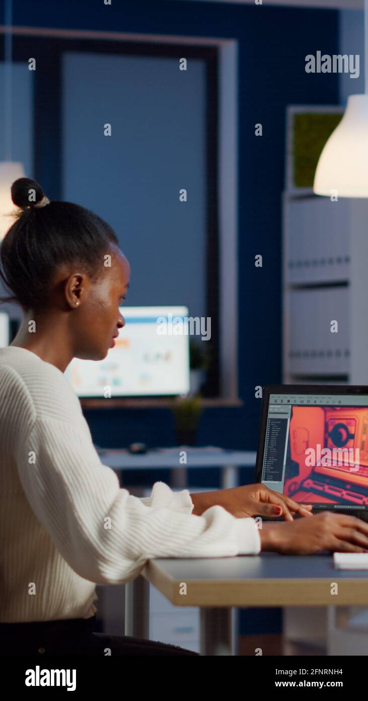Dark skin gamer developer working at video game in midnight from ...