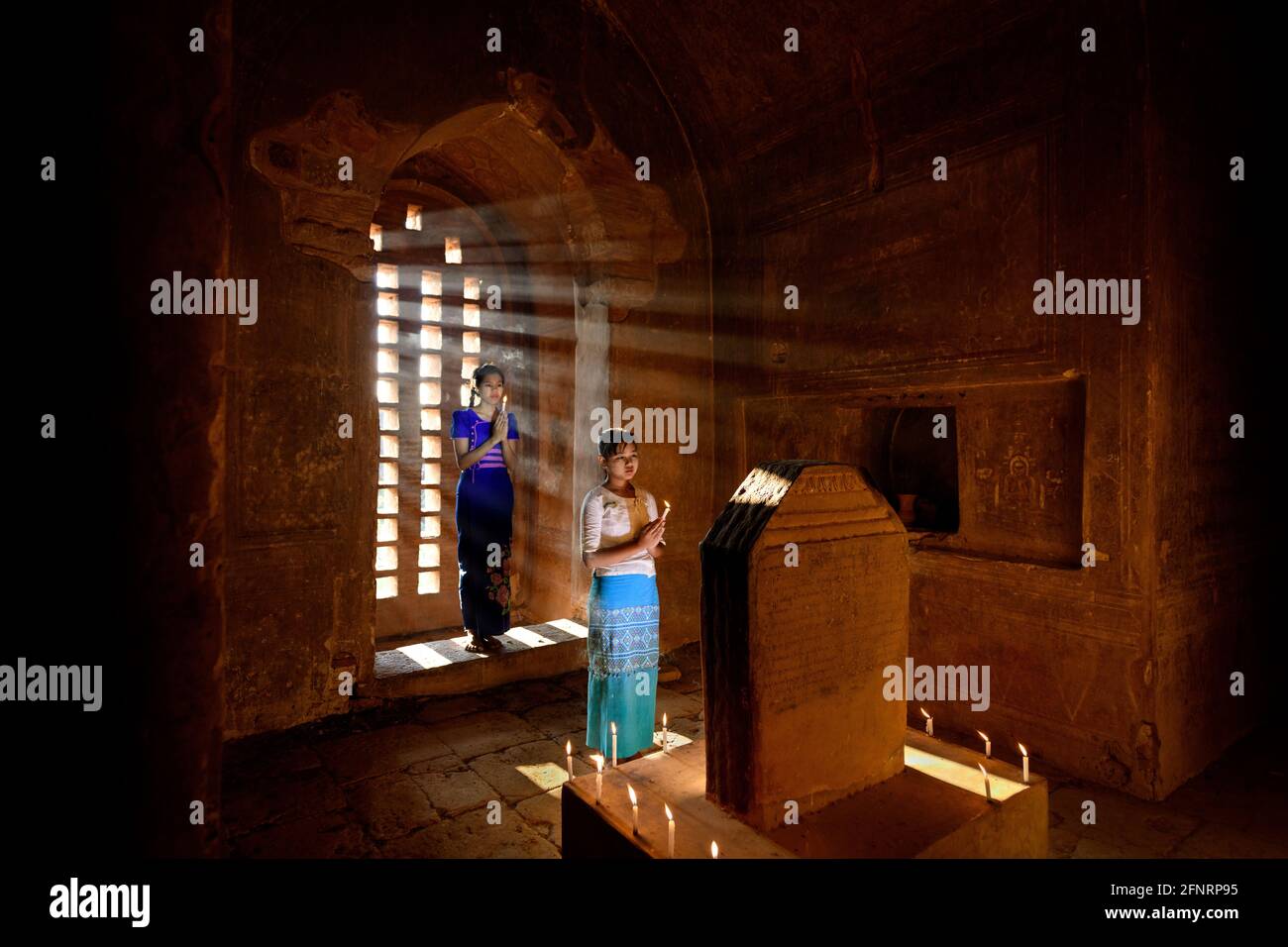 two girls pray in a temple in Bagan, Myanmar Stock Photo - Alamy