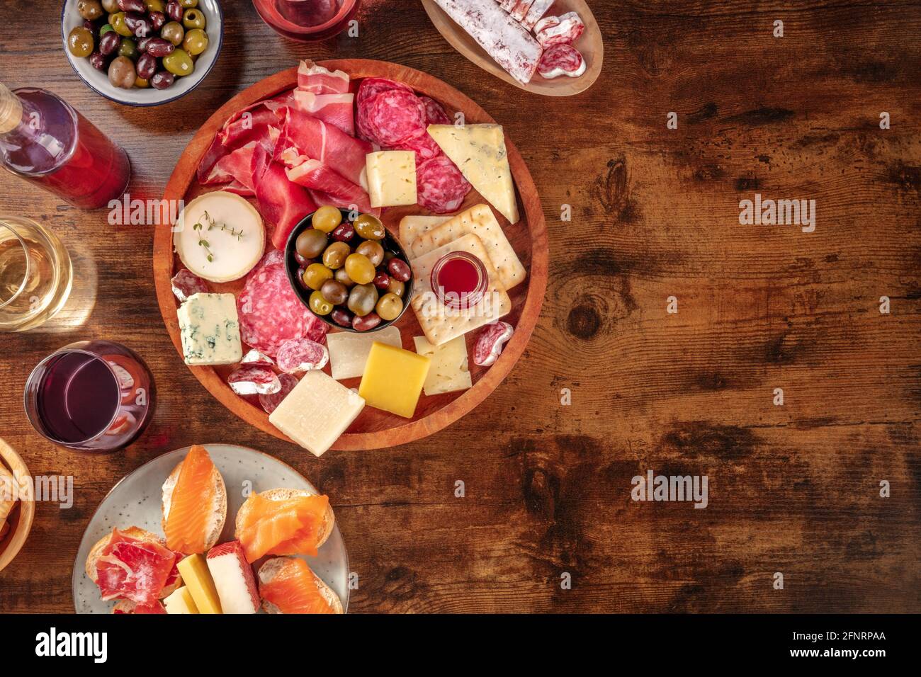 Charcuterie and cheese platter with wine, top shot on a rustic ...