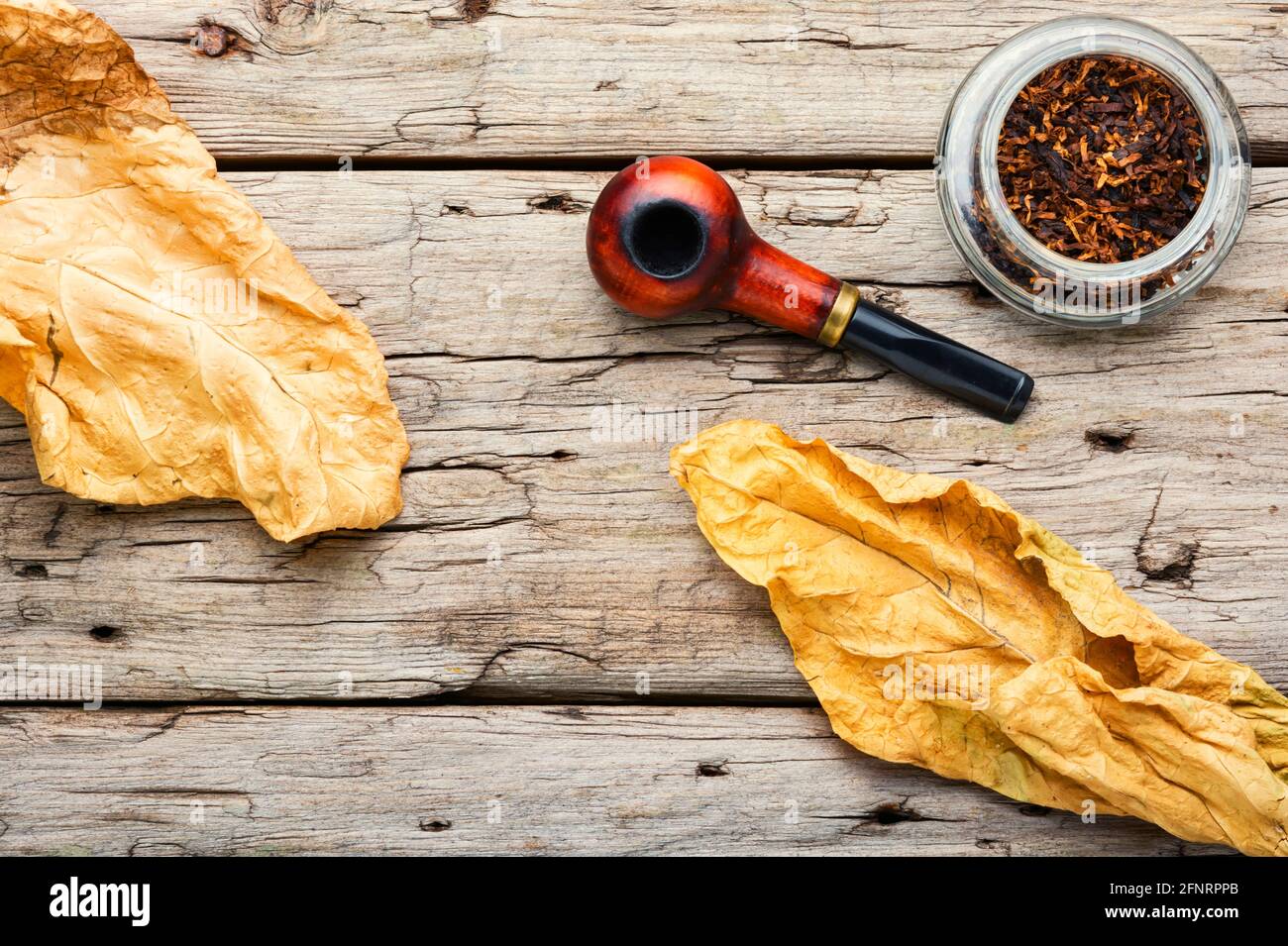 Tobacco pipe, tobacco leaf and pipe tobacco.Smoking pipe on rustic ...