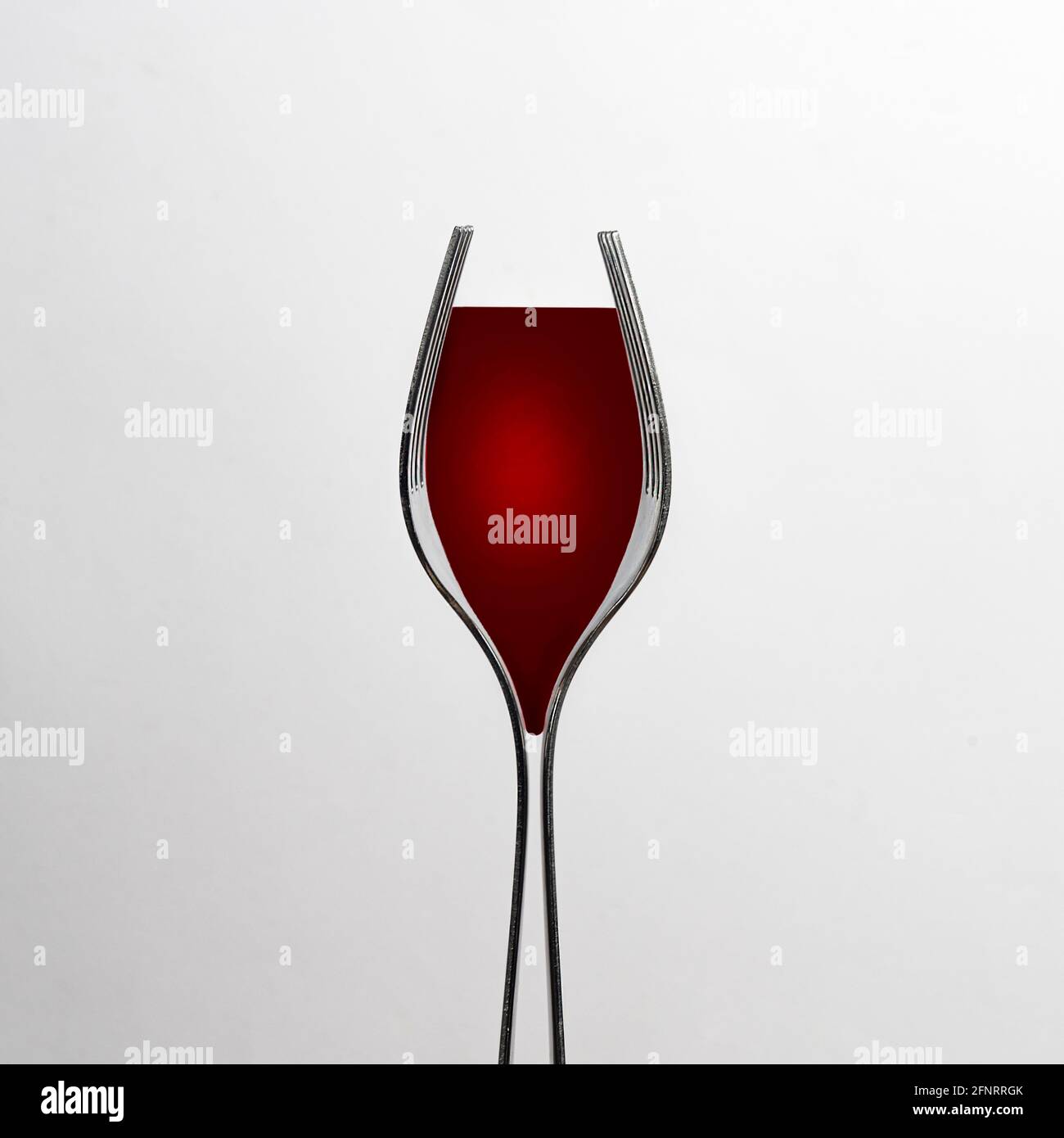 red wine in a glass formed with two forks Stock Photo - Alamy
